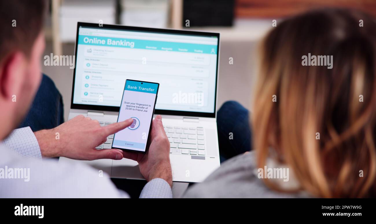 Couple Checking Bank Account Online On Couch Stock Photo - Alamy
