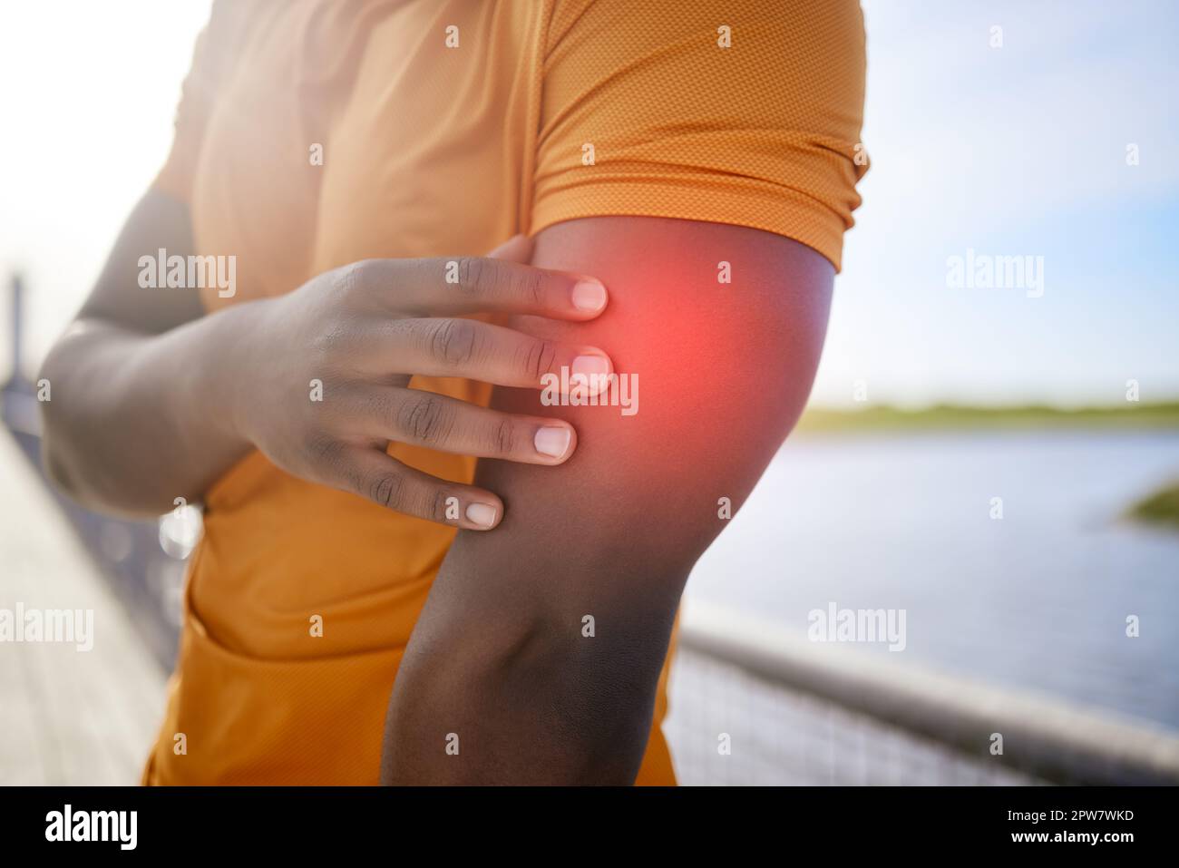 A man with arm pain. A sporty and active African American man is ...