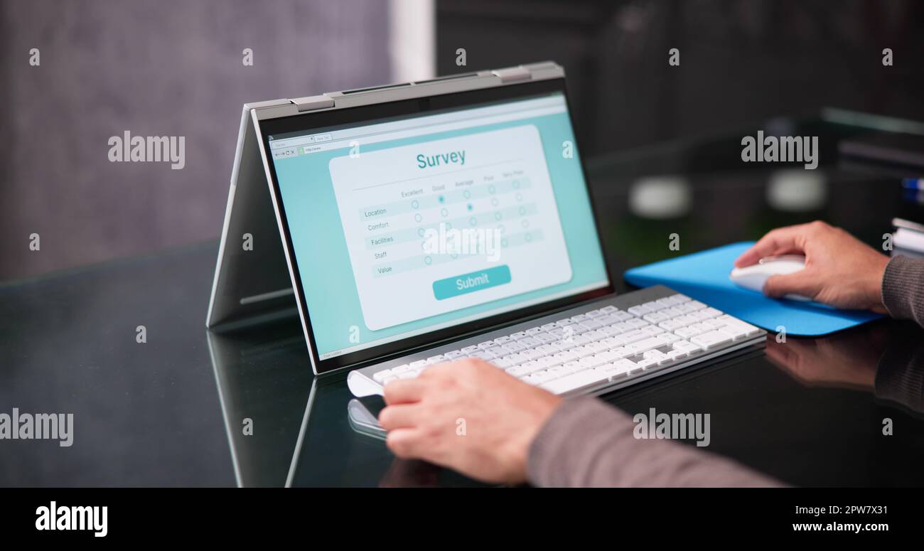 African Man Filling Survey Poll Or Form On Laptop Computer Stock Photo ...