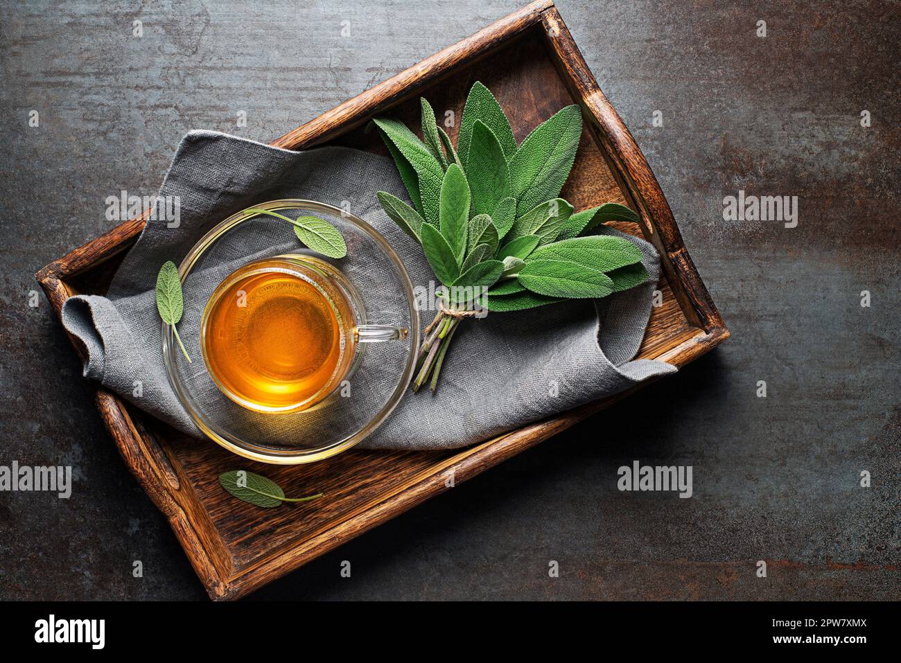 Sage tea in a cup served on a trey close up Stock Photo - Alamy