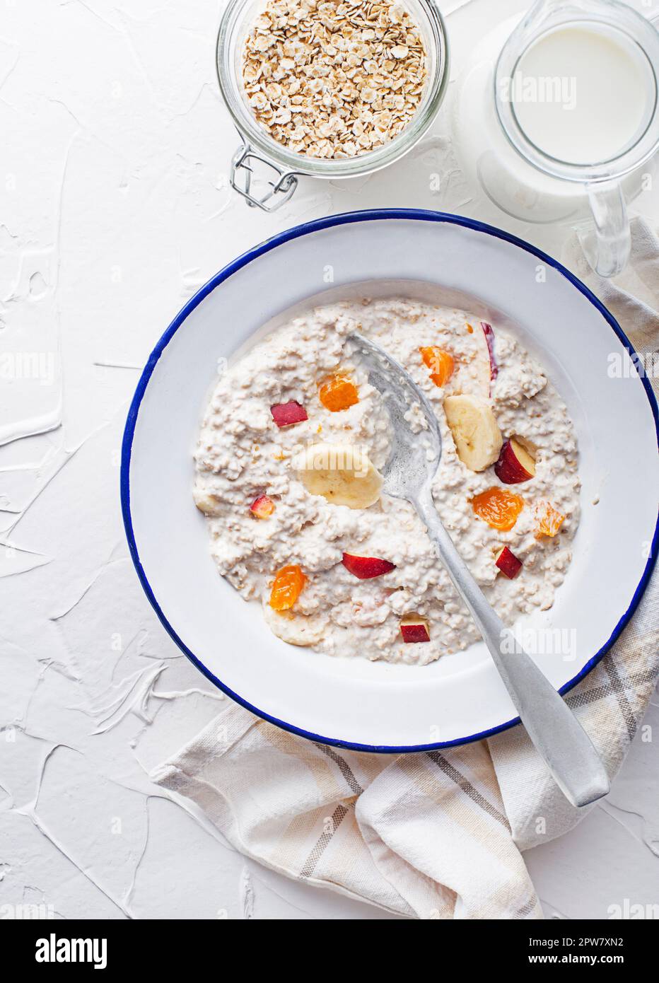 Oatmeal plate. A plate of oatmeal served with fresh fruit and milk ...