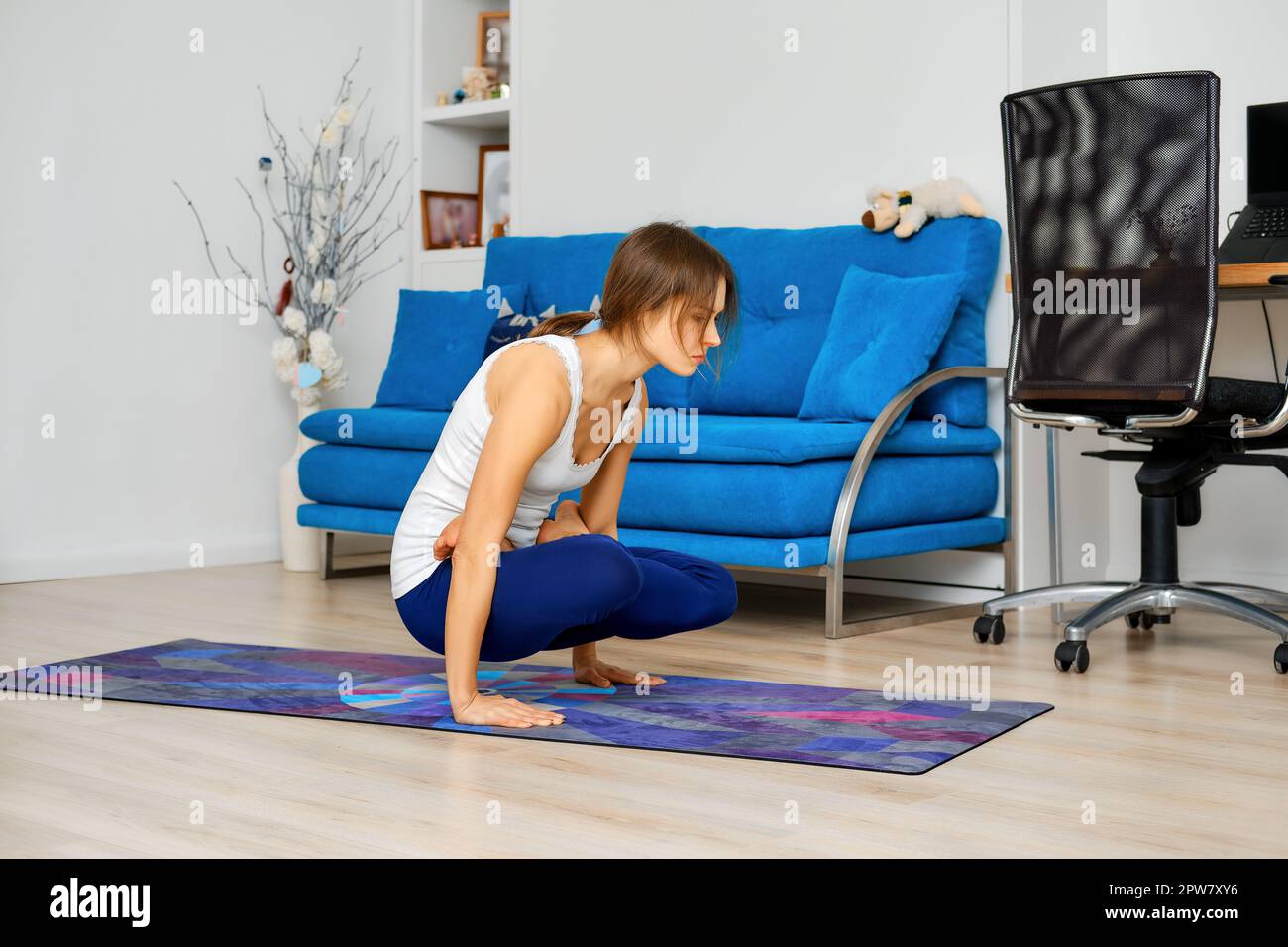 Young woman doing yoga arm balance exercise, crane pose Stock Photo - Alamy