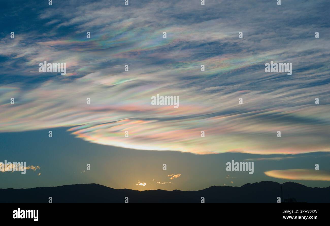 Thin wispy clouds creating rainbow patterns of scattered sunlight ...