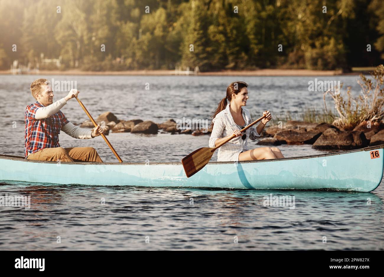 The best days are spent in a canoe. a young couple going for a canoe ...