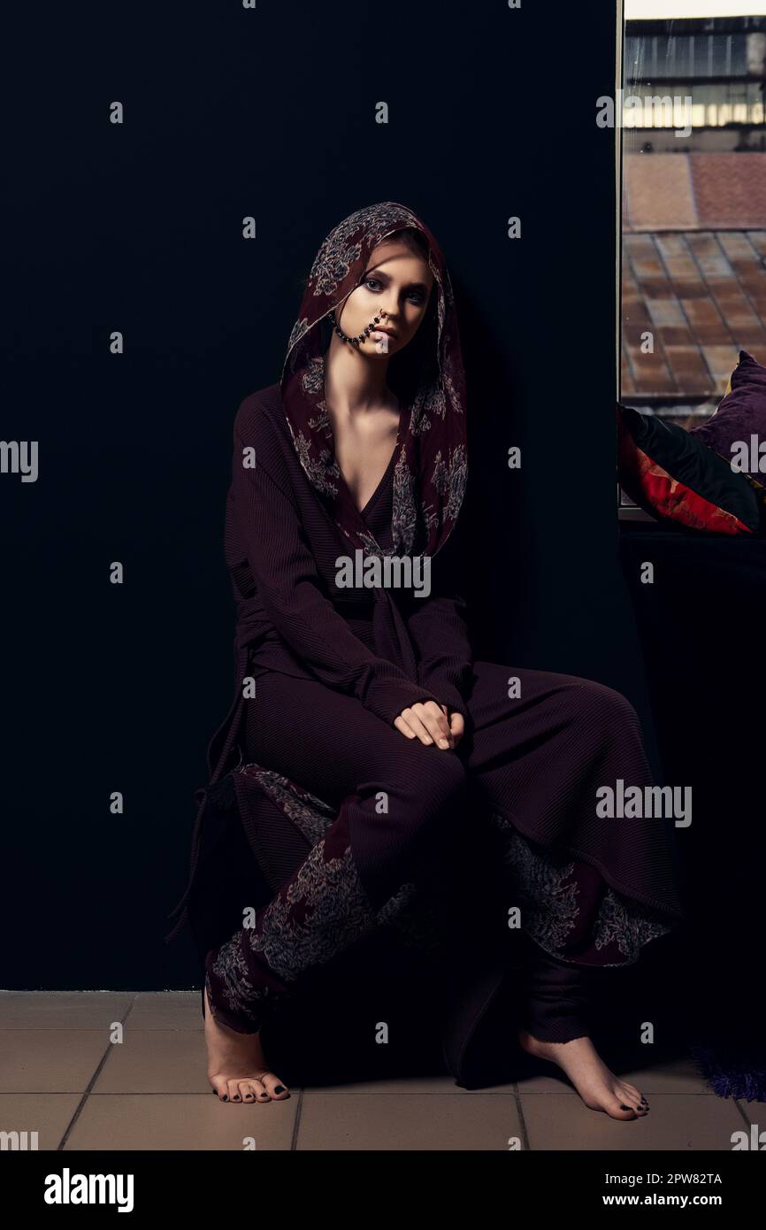 Low key portrait of a girl in bathrobe with hood Stock Photo - Alamy