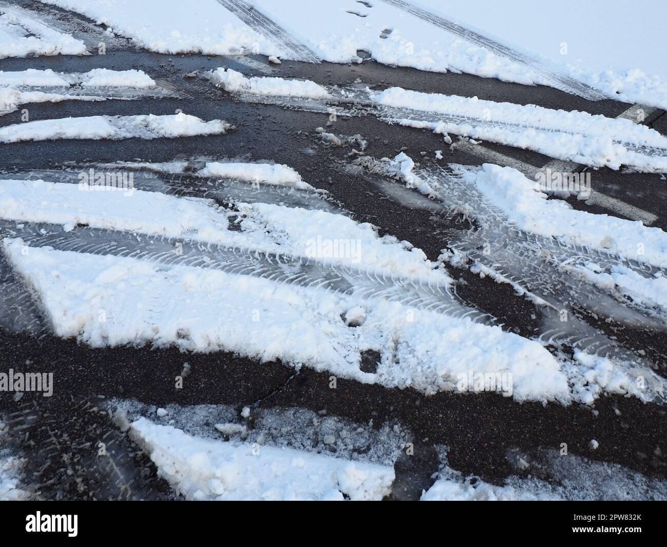A fork or siding from a roundabout. Snowdrifts on the side of the road ...