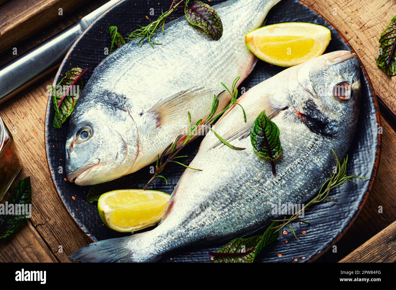 Two raw dorado fish for cooking on a plate. Uncooked fish Stock Photo ...