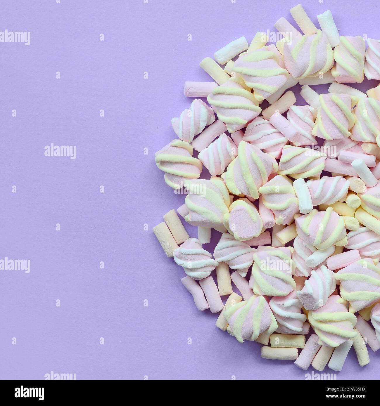 Colorful marshmallow laid out on violet paper background. pastel ...