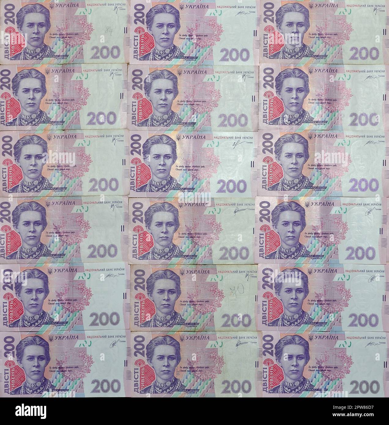 A close-up of a pattern of many Ukrainian currency banknotes with a par ...