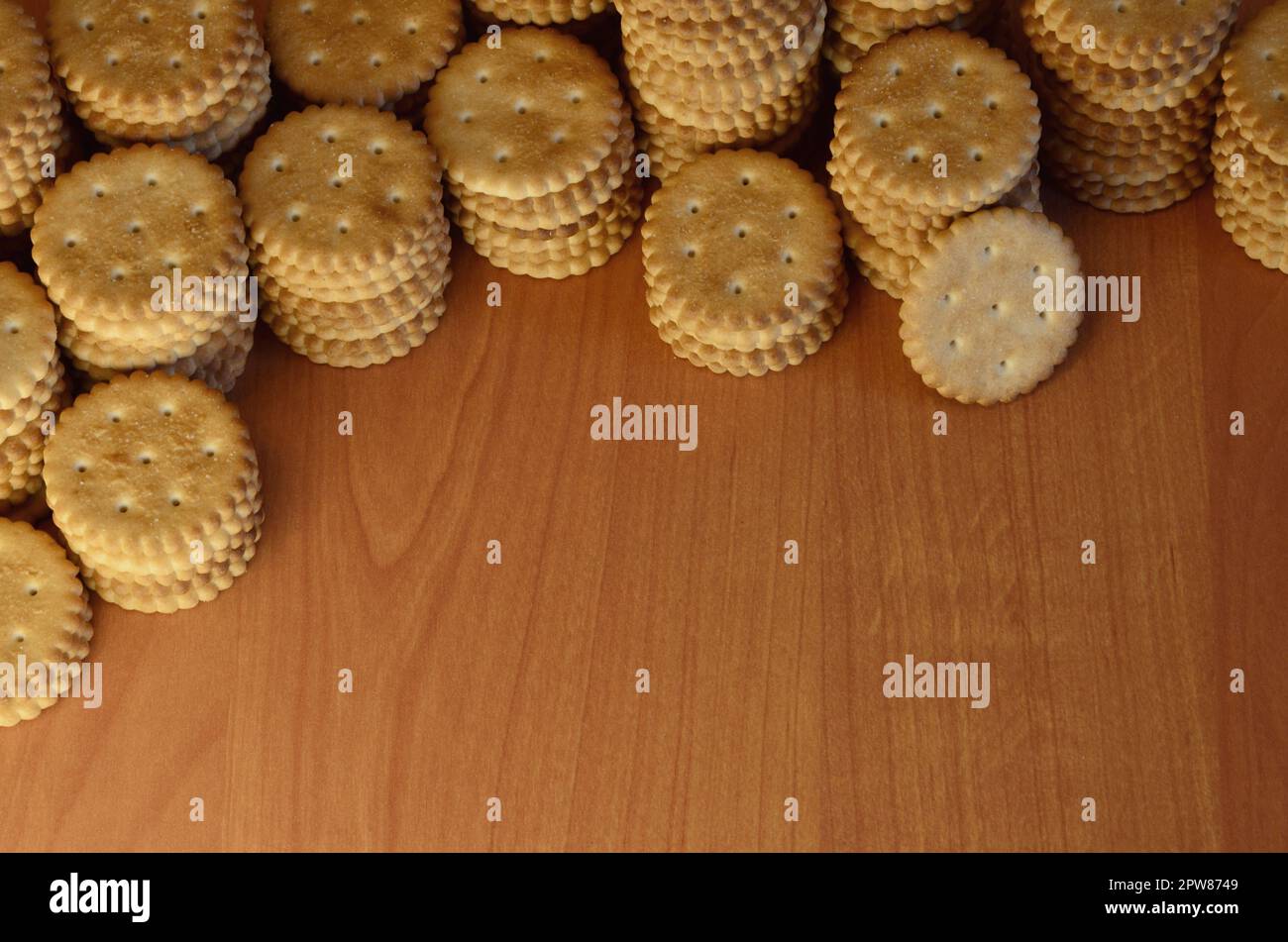 Background image of classic salty cracker on a brown wooden table with ...