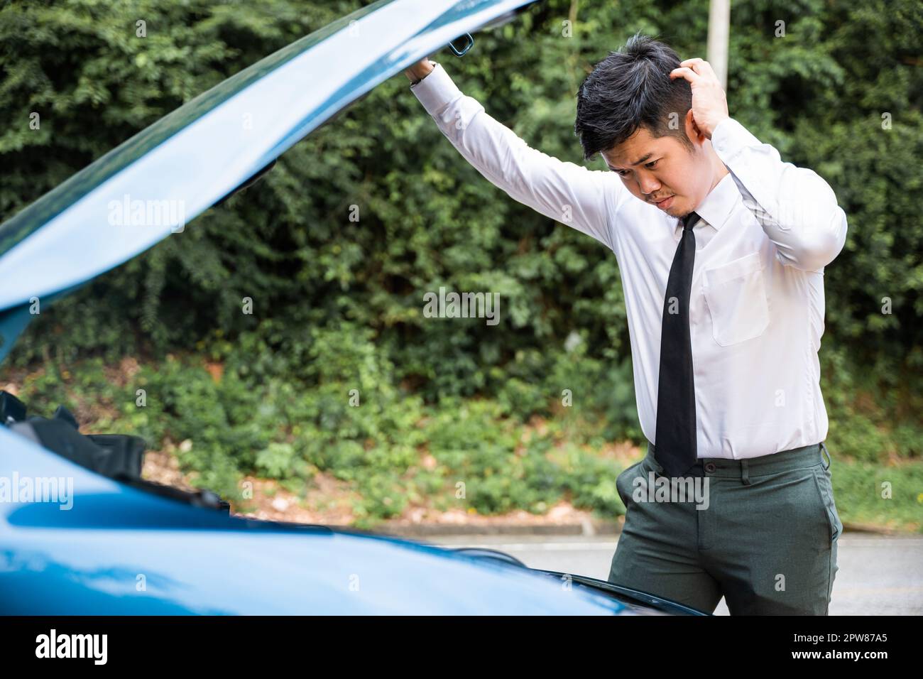 Asian businessman car broken breakdown, angry young stressed man stands ...