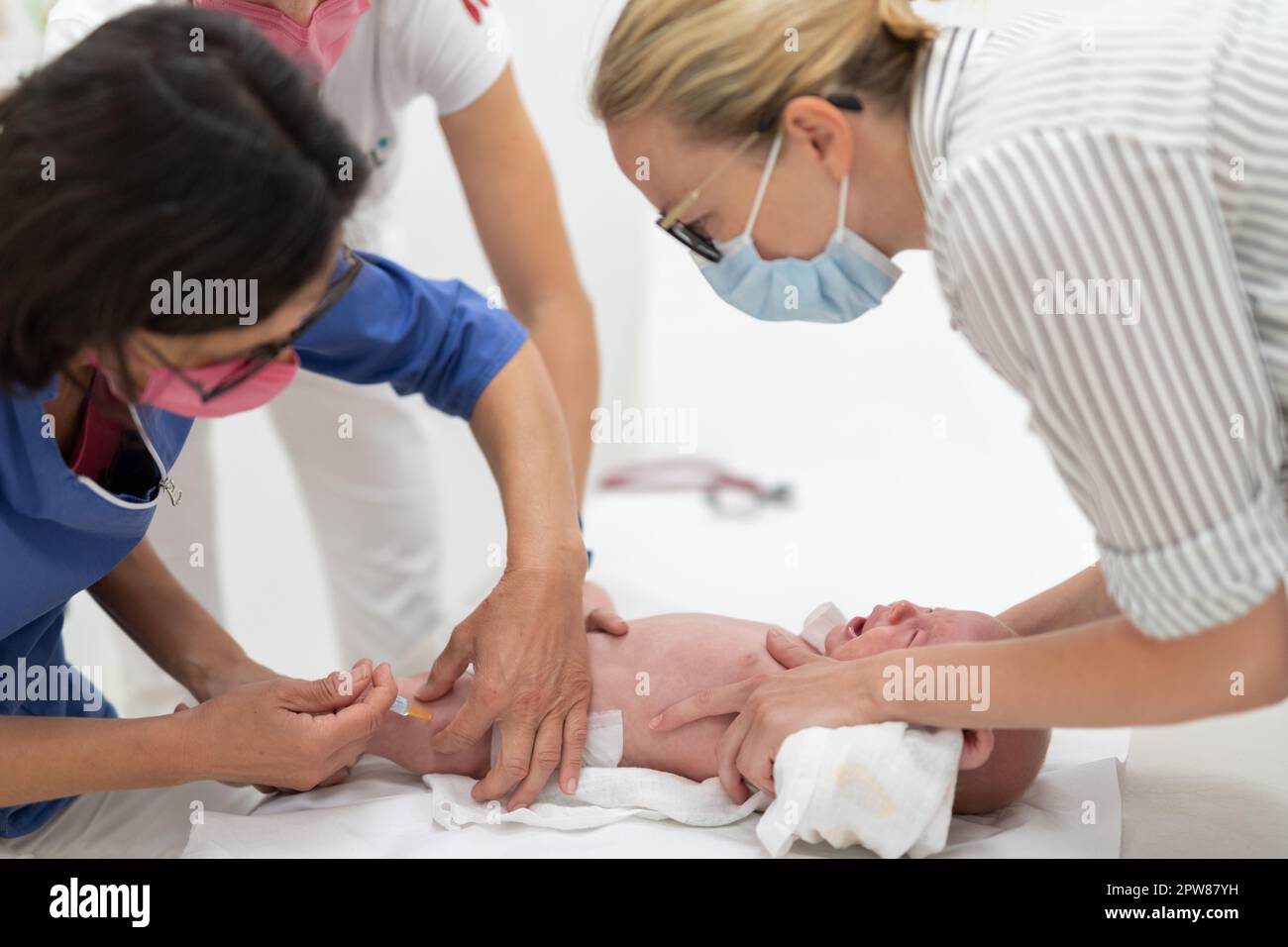 Baby beeing vaccinated by pediatrician in presence of his mother ...