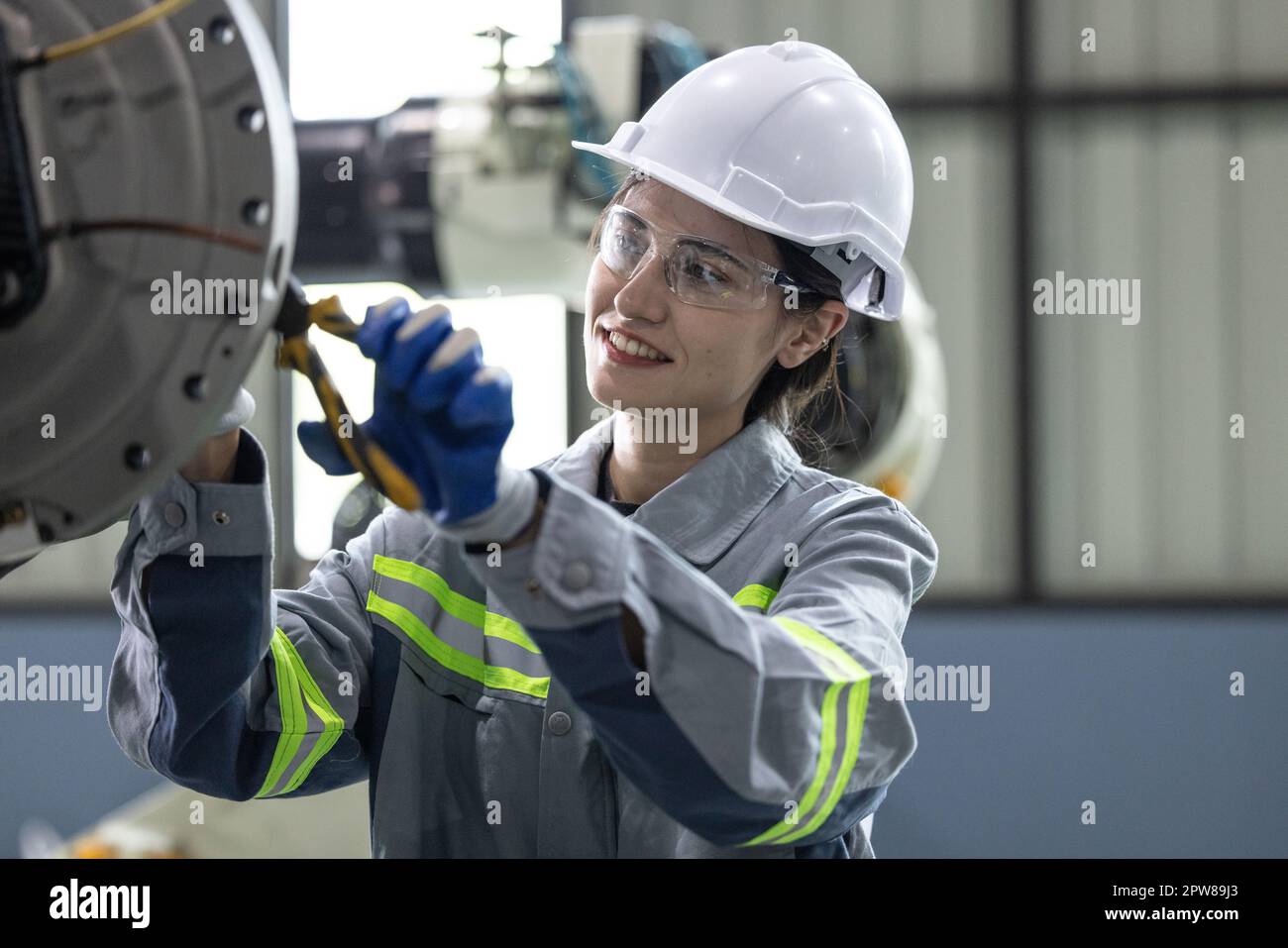 Robotic technicians tighten and loosen components with screwdriver and ...