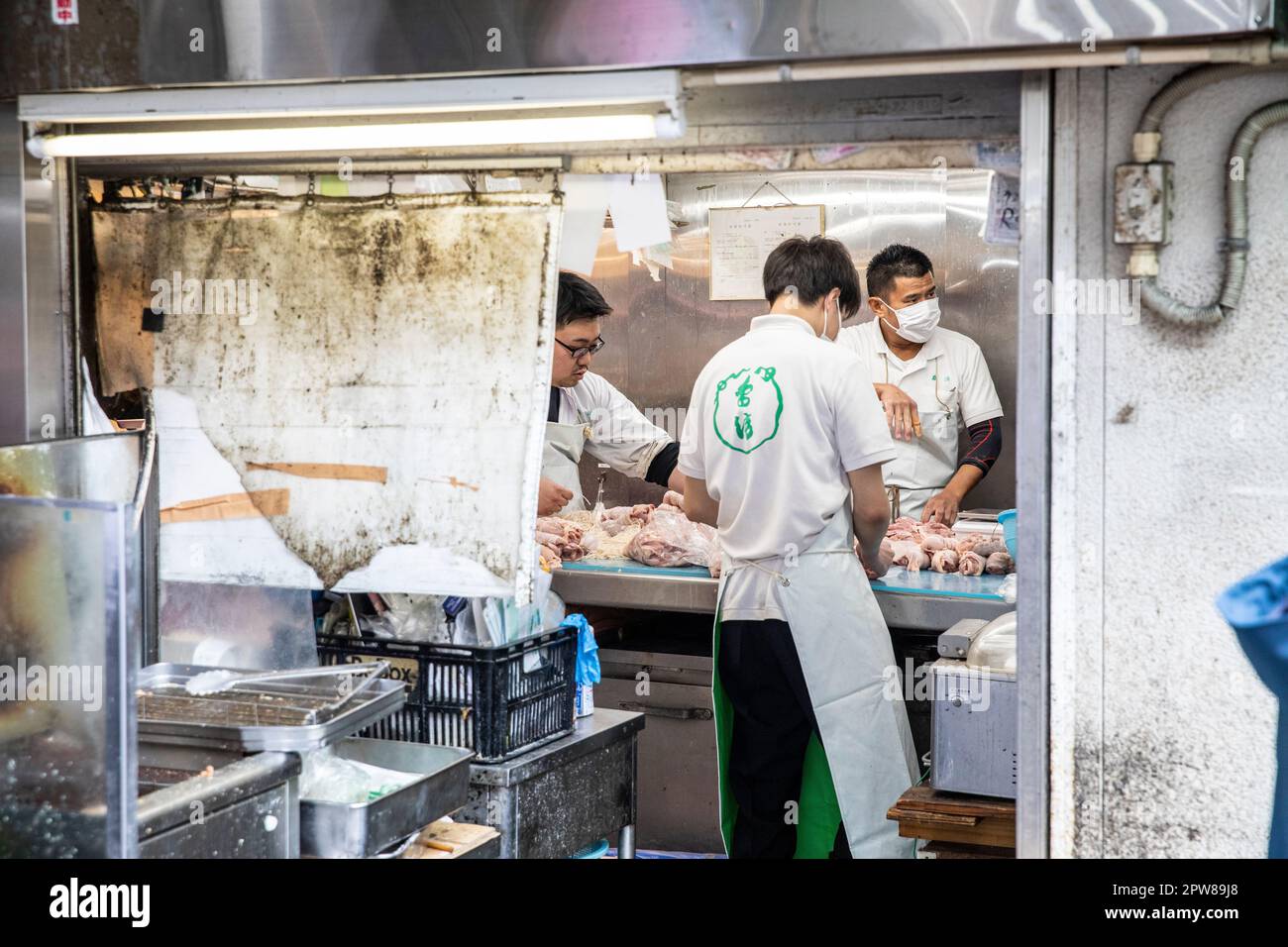 Nishiki market restaurant, kitchen staff cutting up chicken in the ...