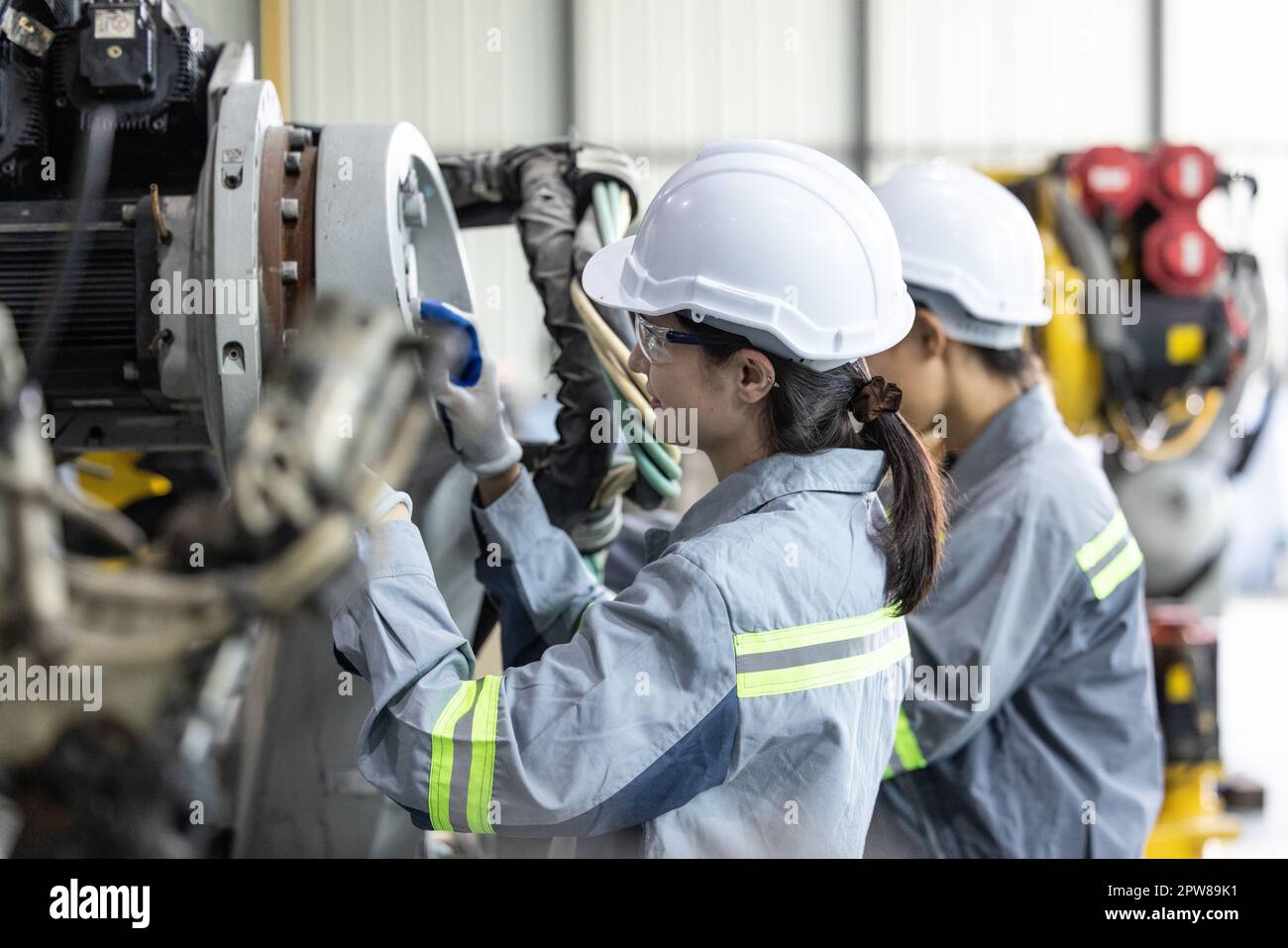 Robotic technicians tighten and loosen components with screwdriver and ...