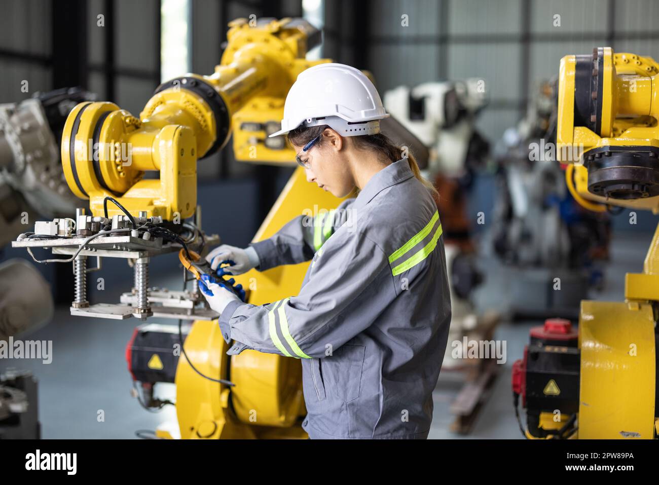 Robotic technicians tighten and loosen components with screwdriver and ...