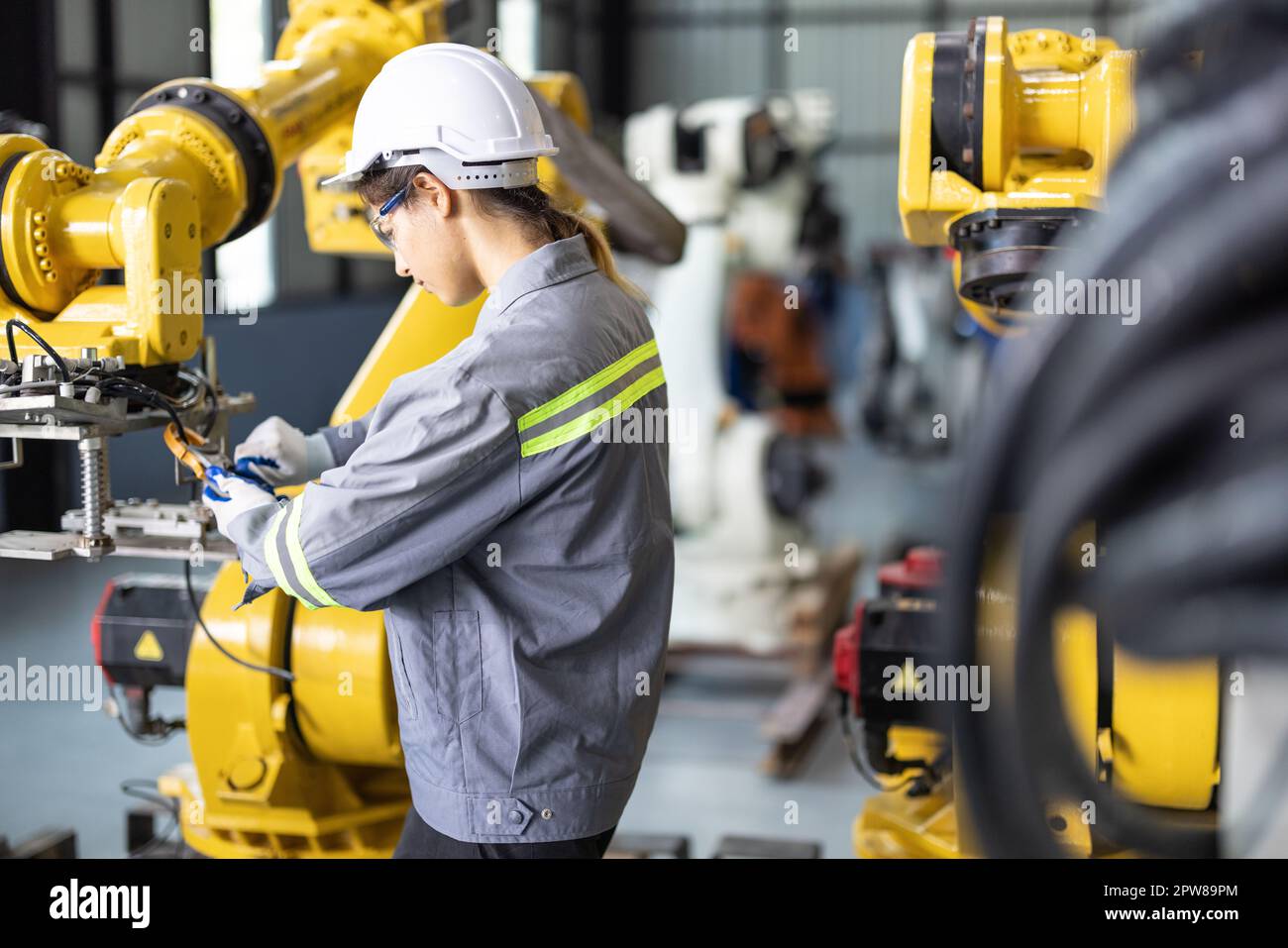 Robotic technicians tighten and loosen components with screwdriver and ...