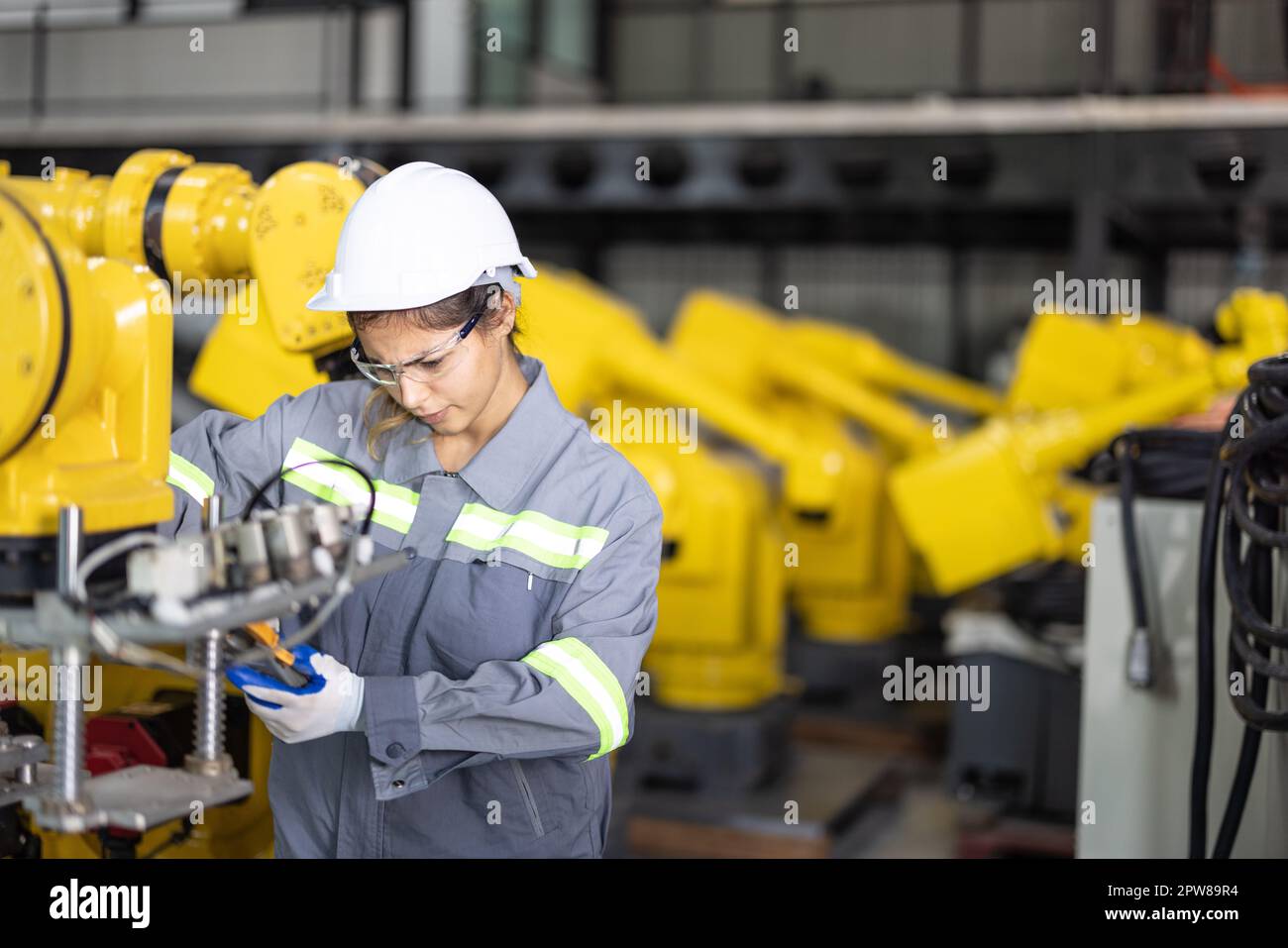 Robotic technicians tighten and loosen components with screwdriver and ...