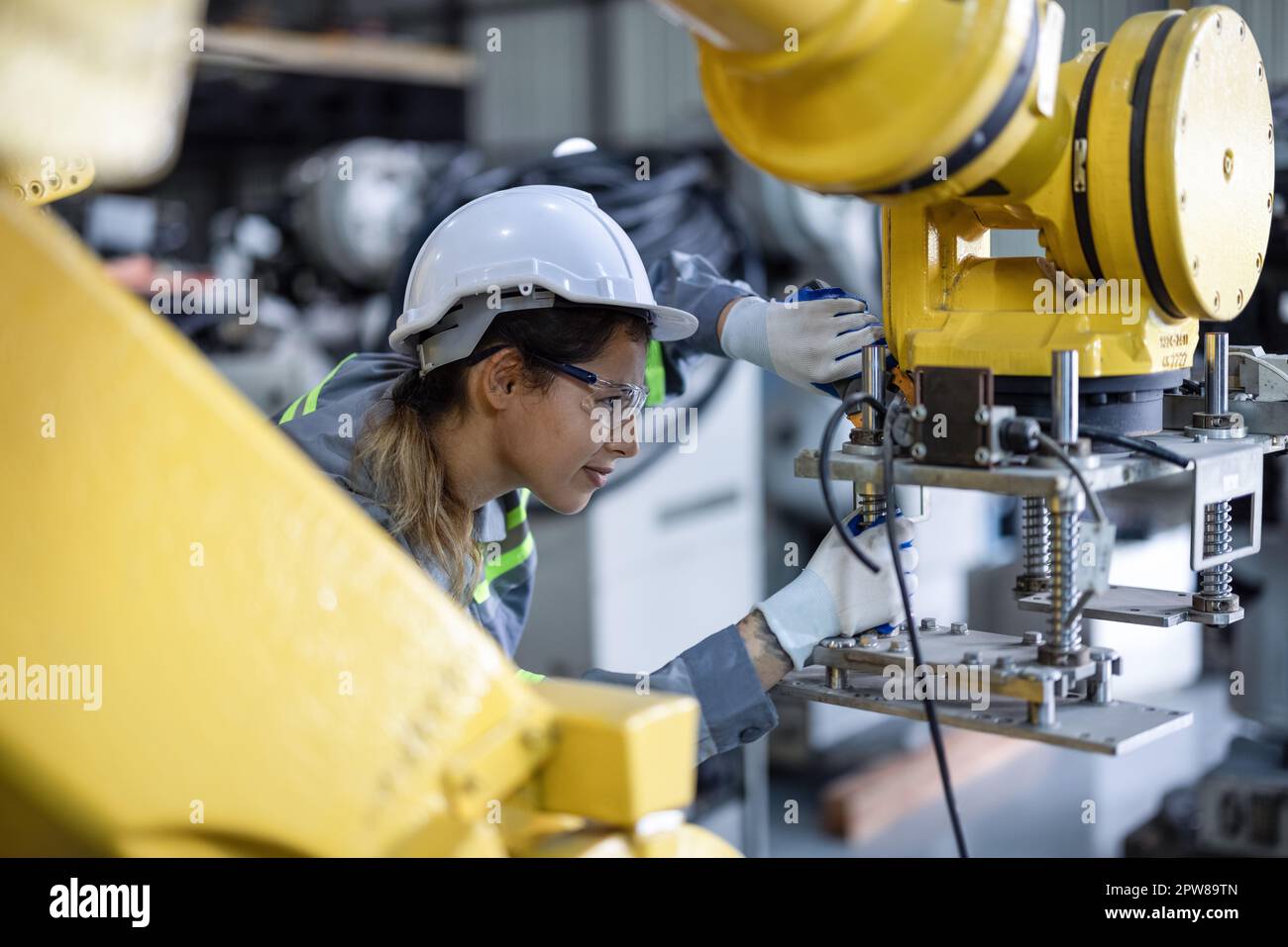 Robotic technicians tighten and loosen components with screwdriver and ...