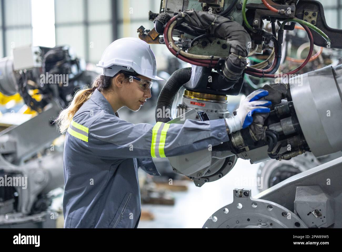 Robotic technicians tighten and loosen components with screwdriver and plier to perform safety ...