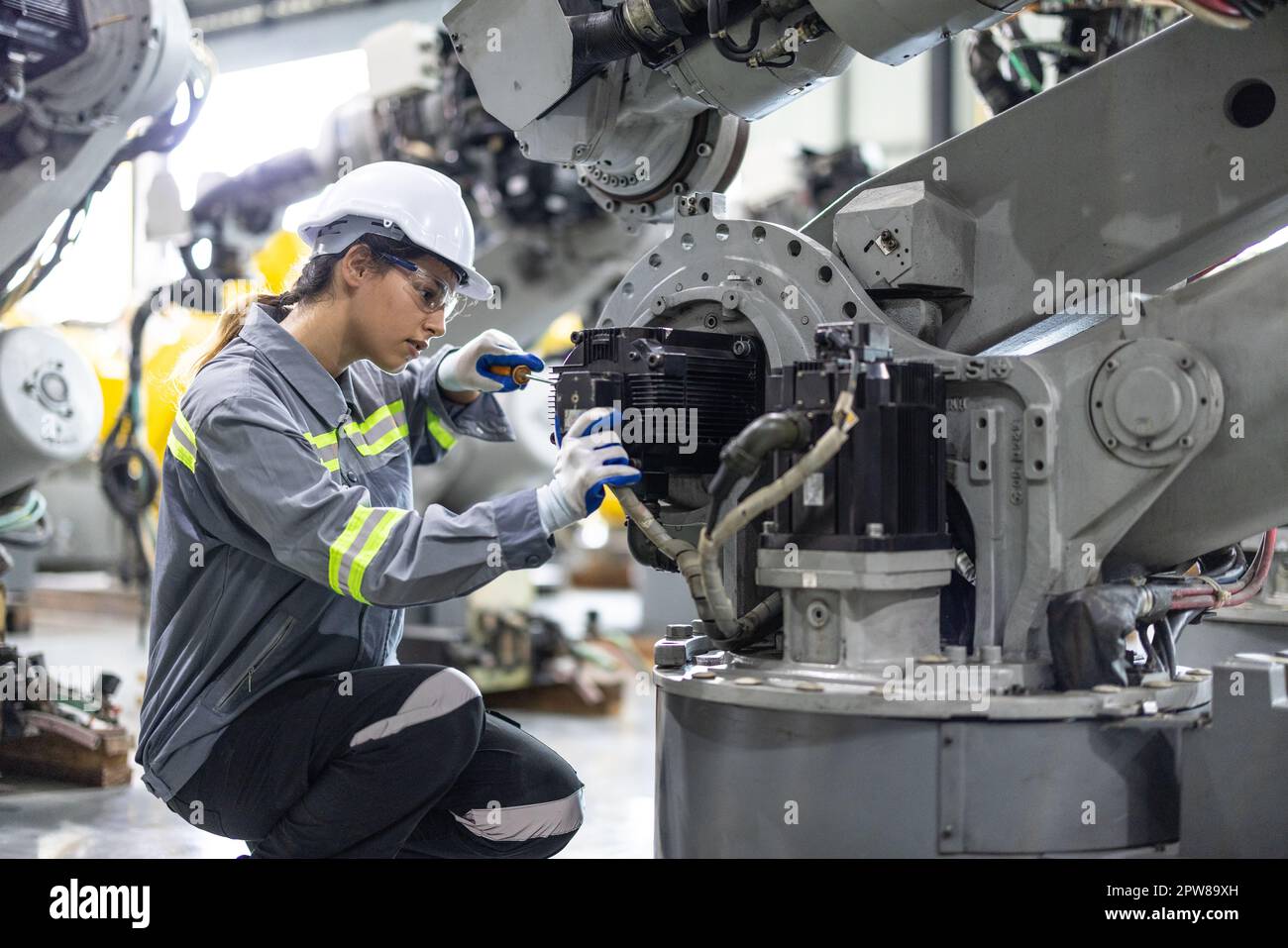 Robotic technicians tighten and loosen components with screwdriver and ...