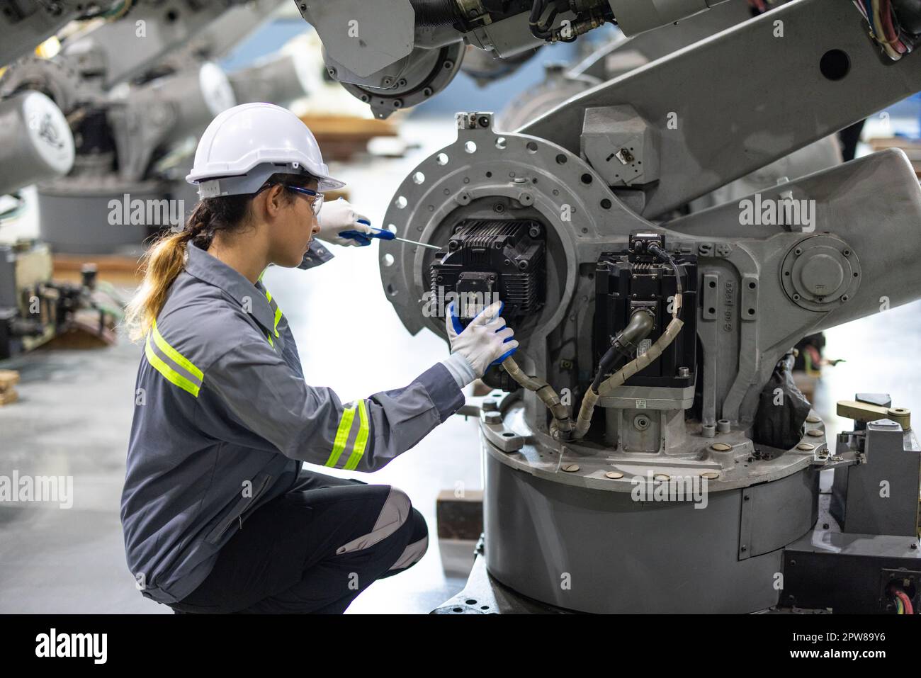 Robotic technicians tighten and loosen components with screwdriver and ...