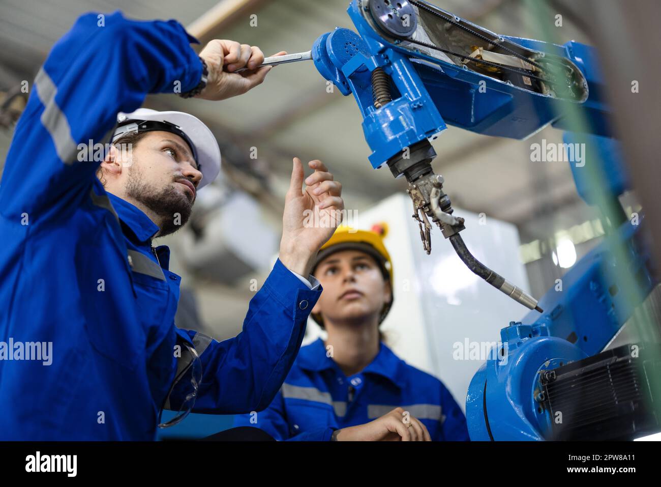 Robotic technicians tighten and loosen components with screwdriver and ...