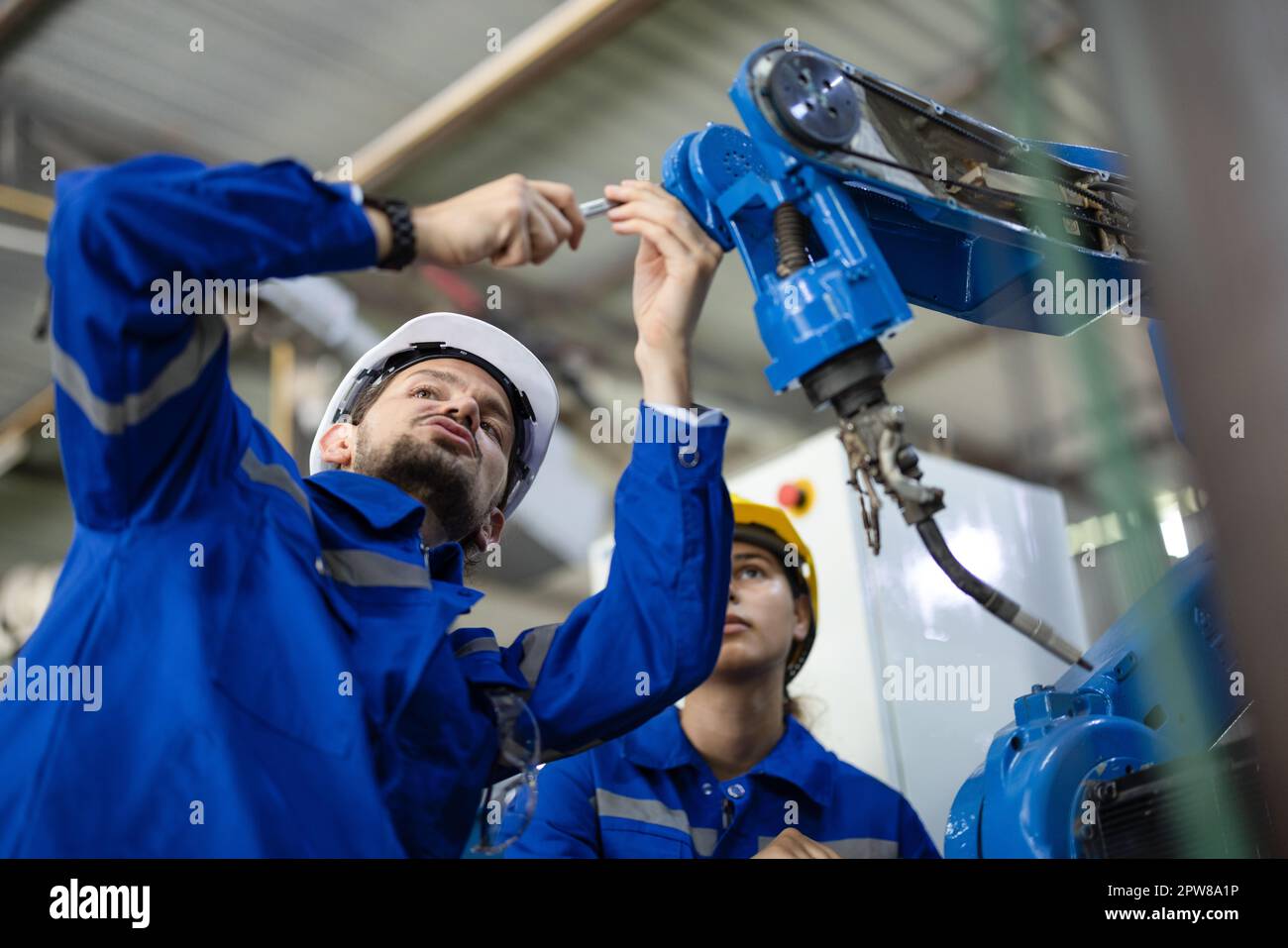 Robotic technicians tighten and loosen components with screwdriver and ...