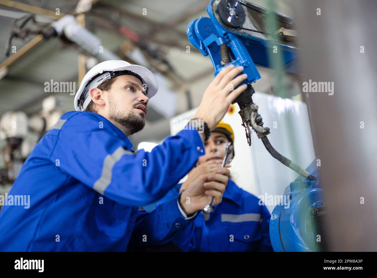 Robotic technicians tighten and loosen components with screwdriver and ...