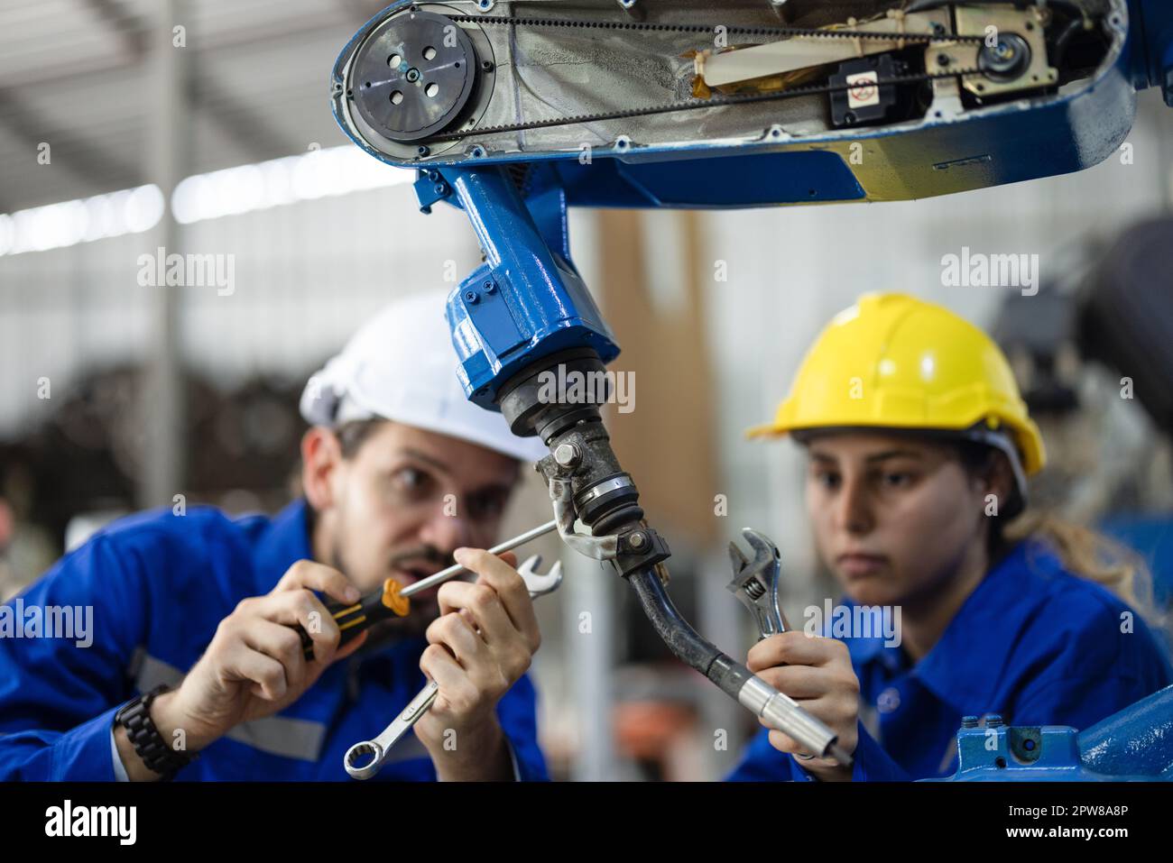 Robotic technicians tighten and loosen components with screwdriver and ...