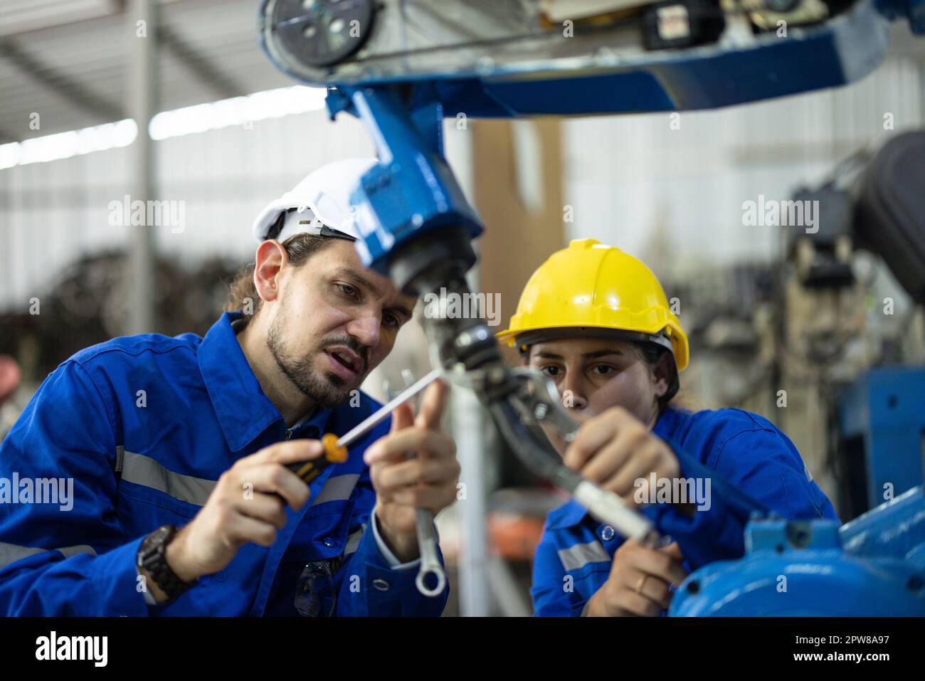 Robotic technicians tighten and loosen components with screwdriver and ...