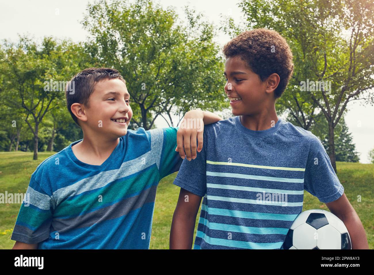 Friends and football, the perfect combination. two young boys out for a ...