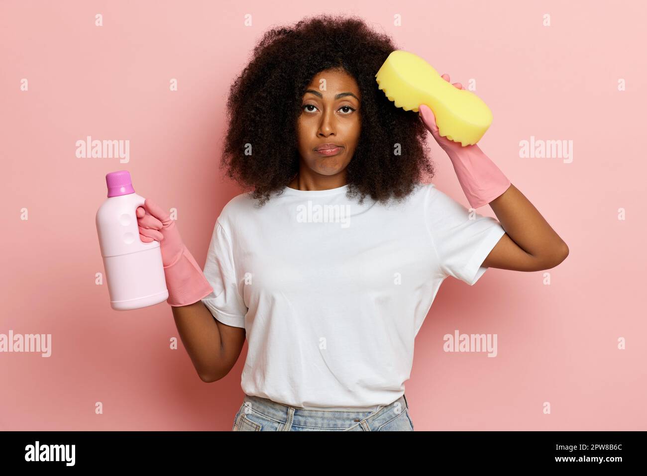 a housewife is tired of cleaning, she put her hand to her forehead and ...