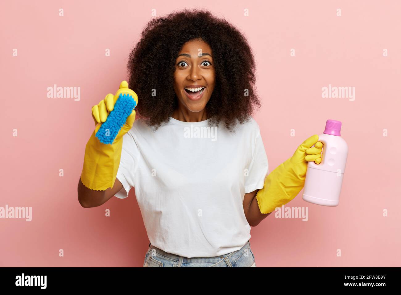 happy housewife, finishing her cleaning process, she wears white t ...