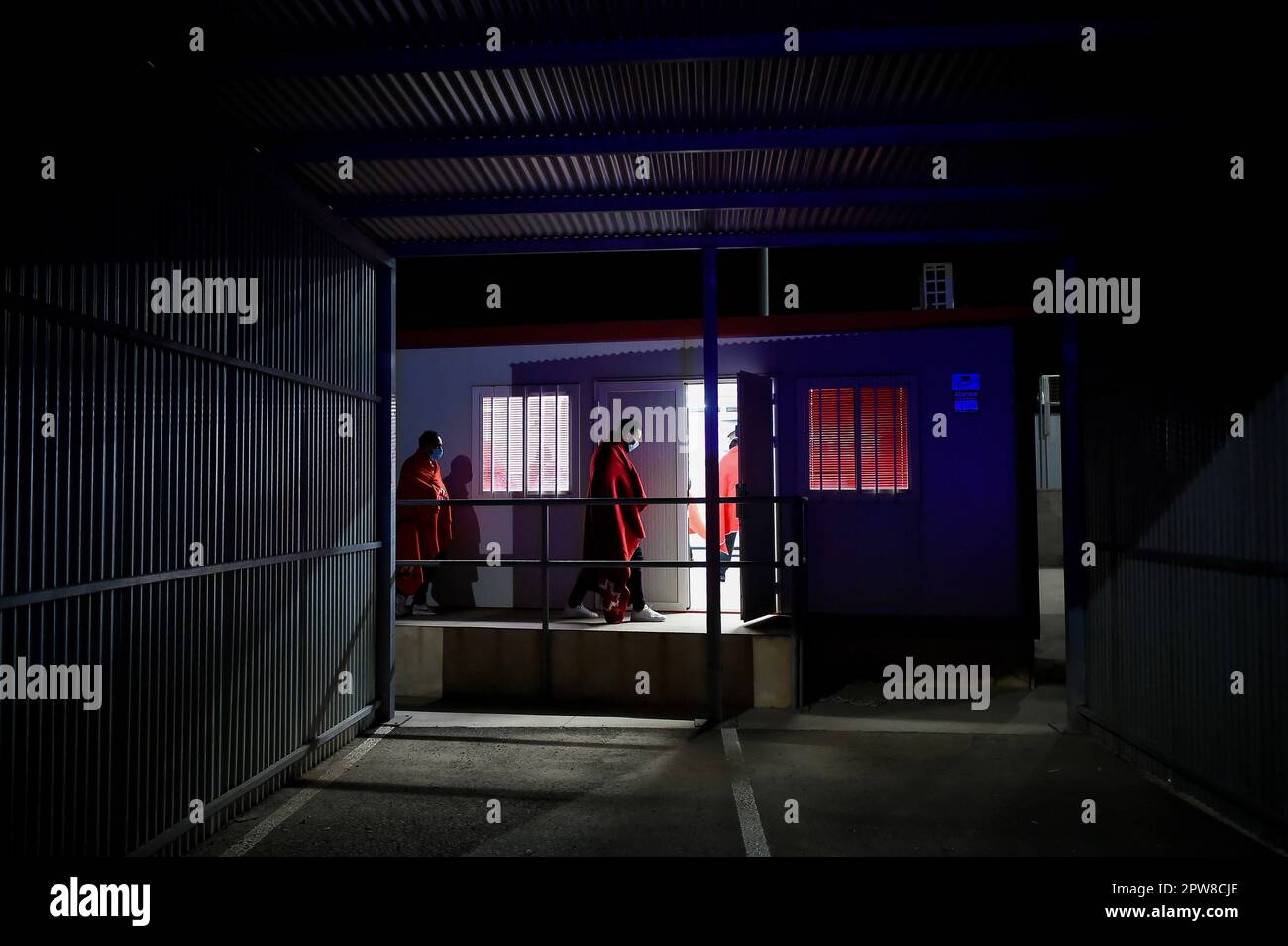 Migrants, who were rescued from a dinghy at the Mediterranean Sea, are ...