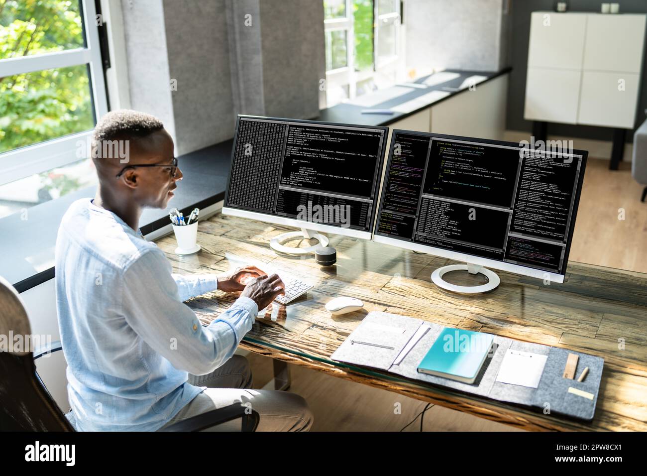 African American Coder Using Computer At Desk. Web Developer Stock Photo - Alamy