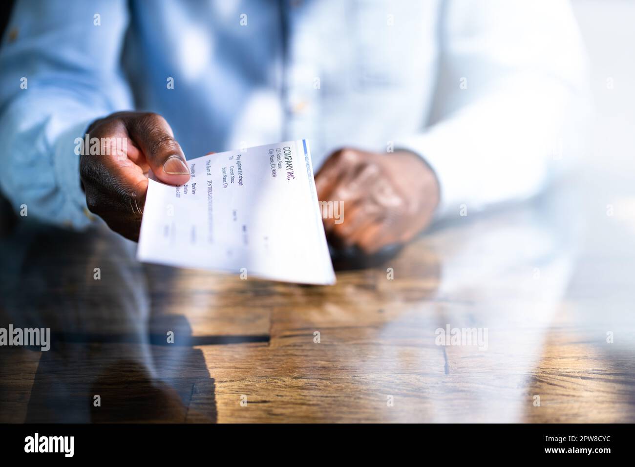 African Business Man Giving Paycheck Or Payroll Cheque Stock Photo - Alamy