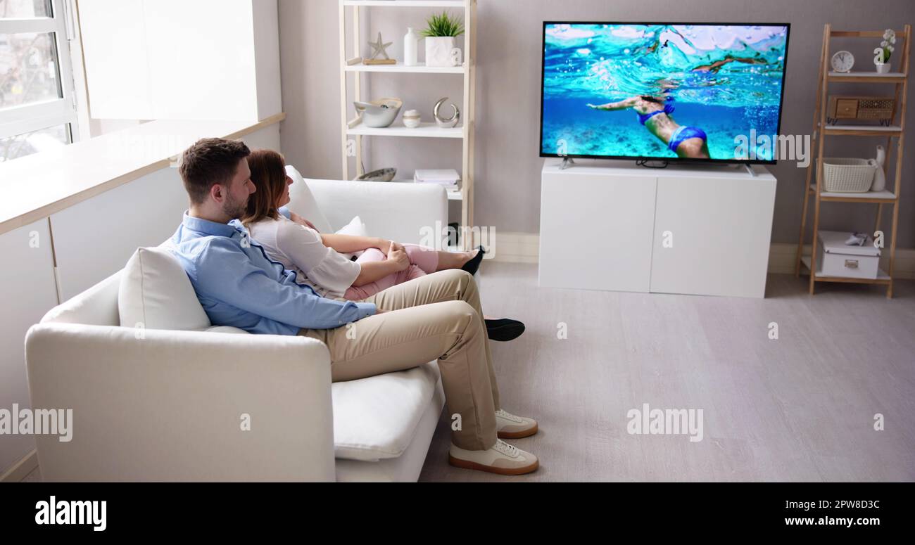 Rear View Of A Couple Watching Movie On Television At Home Stock Photo ...