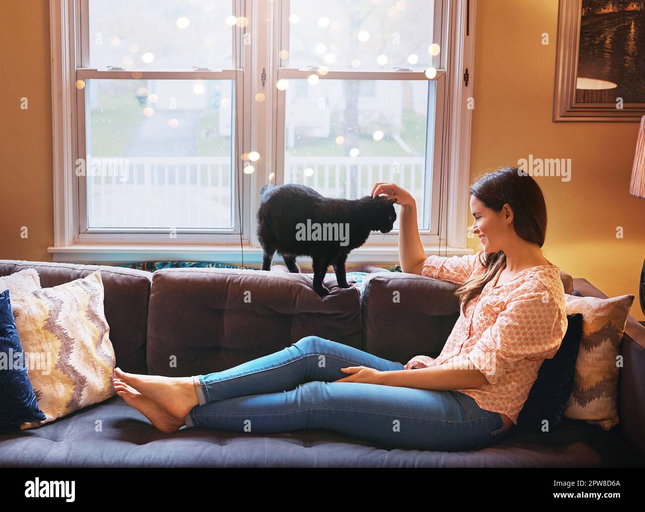 Happiness is having a cat in the home. an attractive young woman ...
