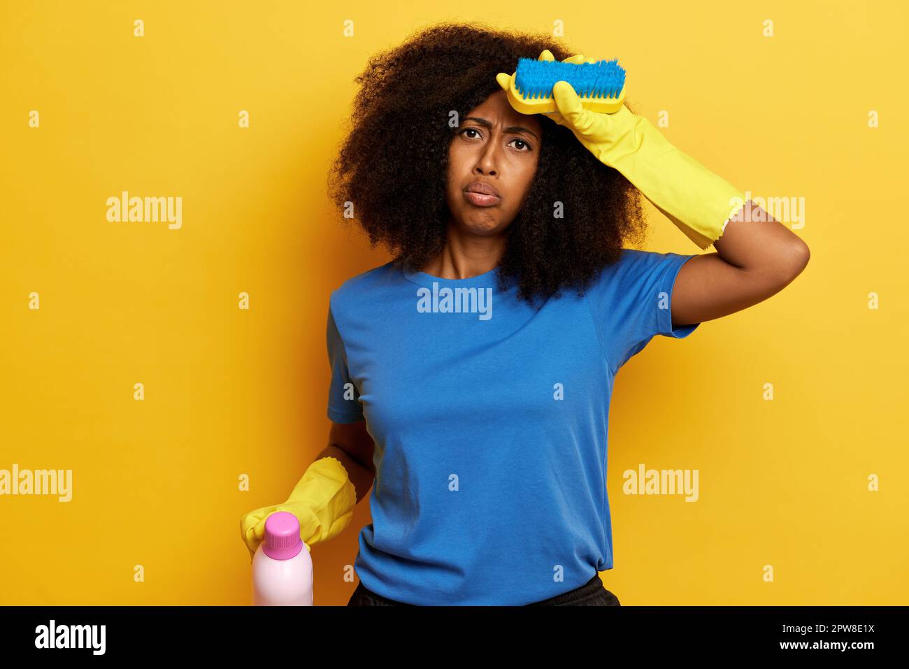 Tired African American woman after hard cleaning process, she puts her ...