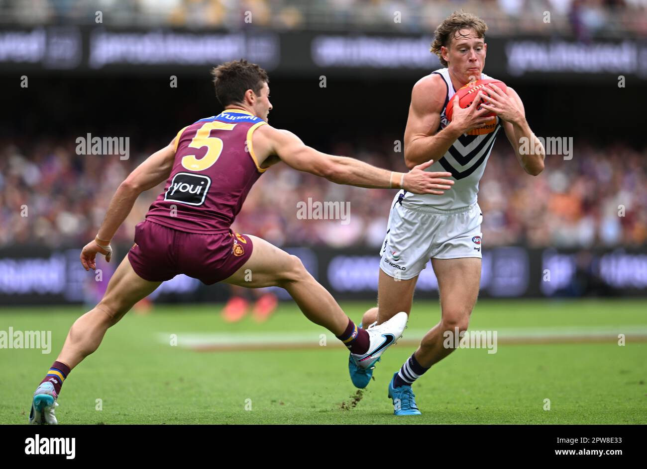 Matthew Johnson (right) of the Dockers is tackled by Josh Dunkley (left ...