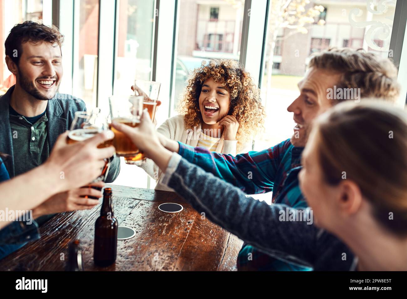 Group beer inside drinking cheers hi-res stock photography and images ...