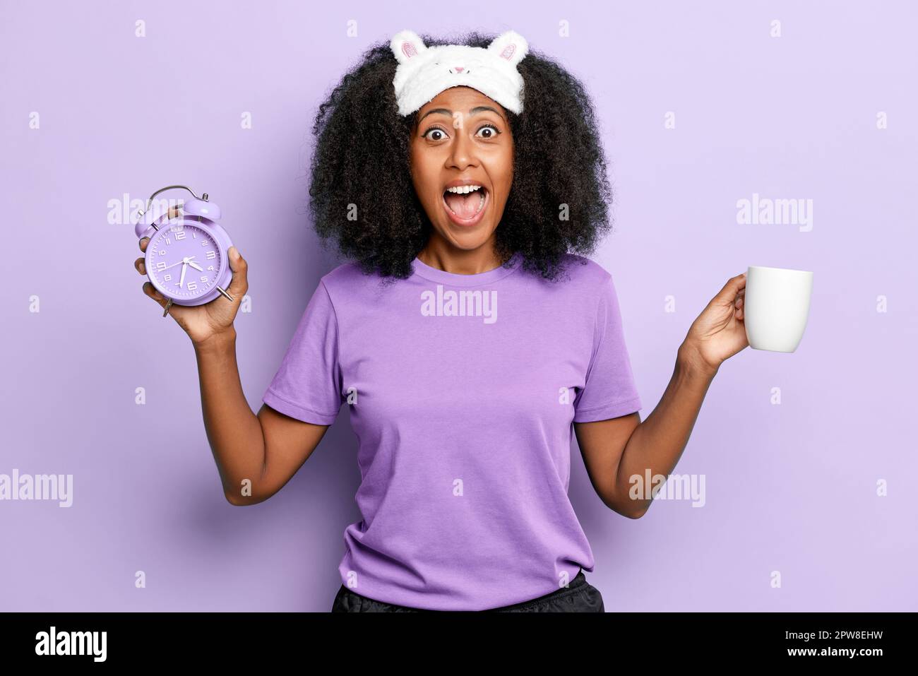 Attractive curly haired woman with sleeping mask on the face, woke up ...