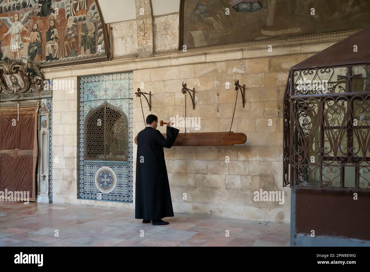 Jerusalem, Israel - November 12th, 2022: An armenian priest using a ...