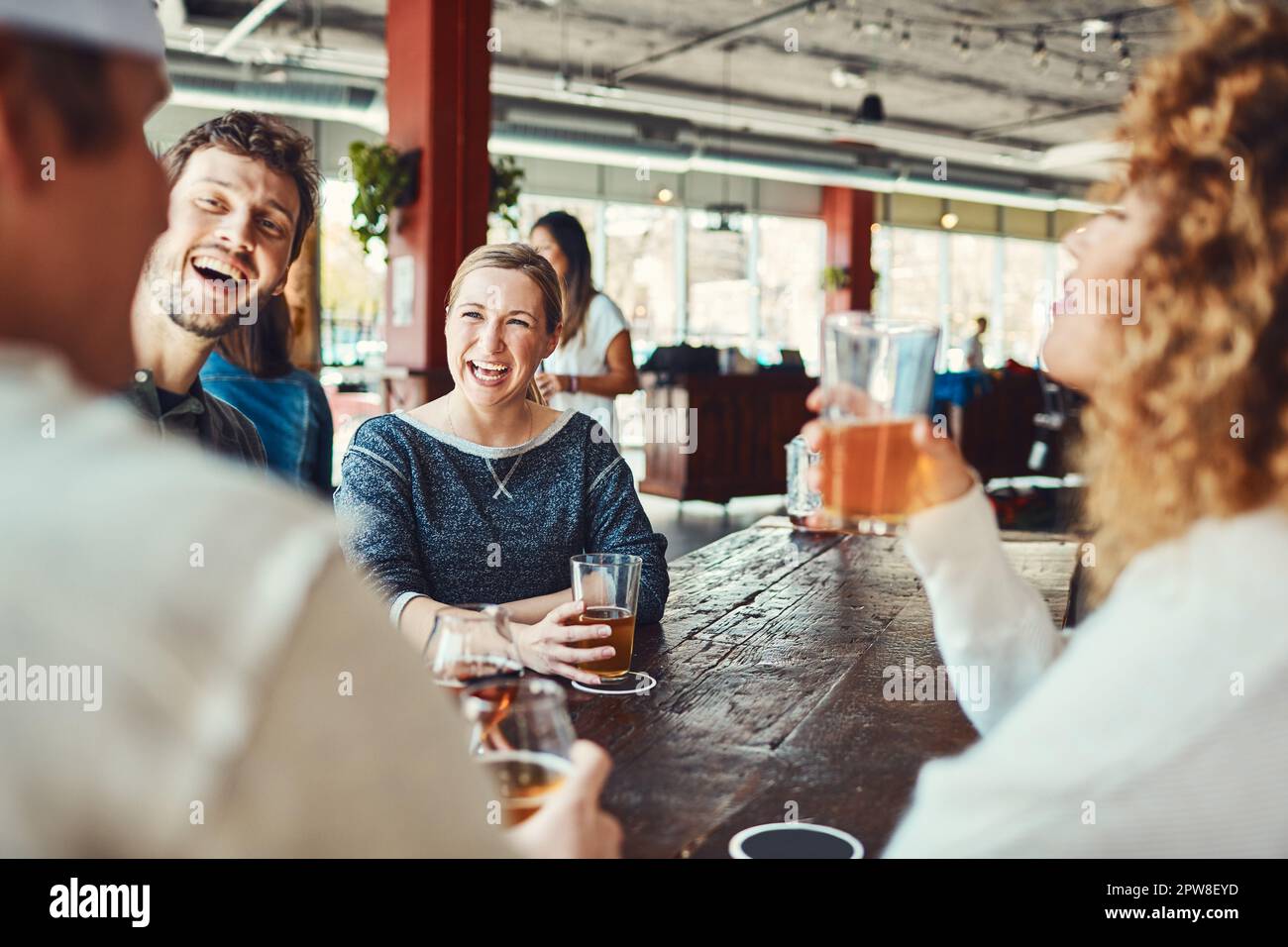 Let the good times roll. a group of friends enjoying some beers at a ...