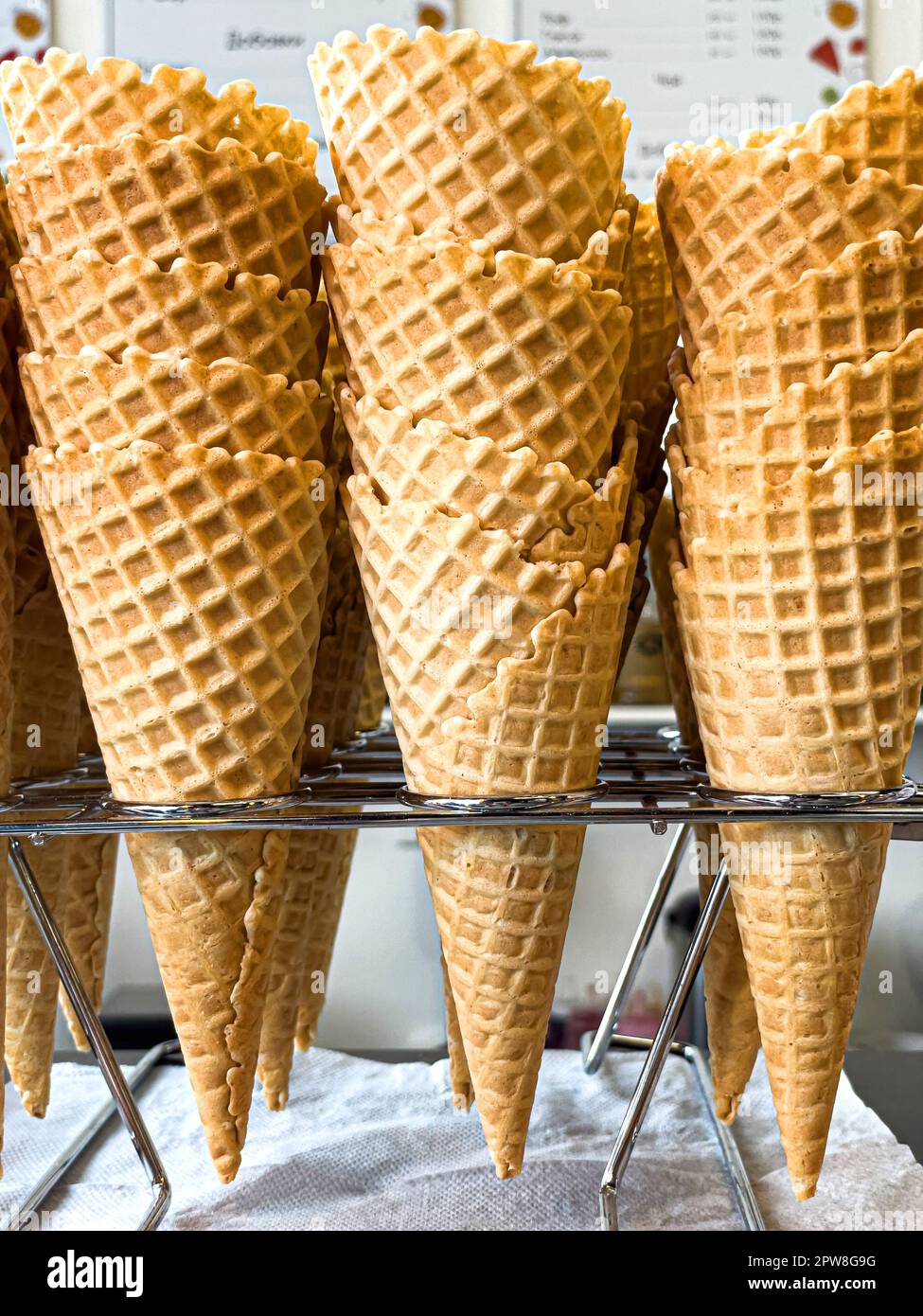 A pile of waffle cones for ice cream ready to be filled with ice cream in a cafe, restaurant ...