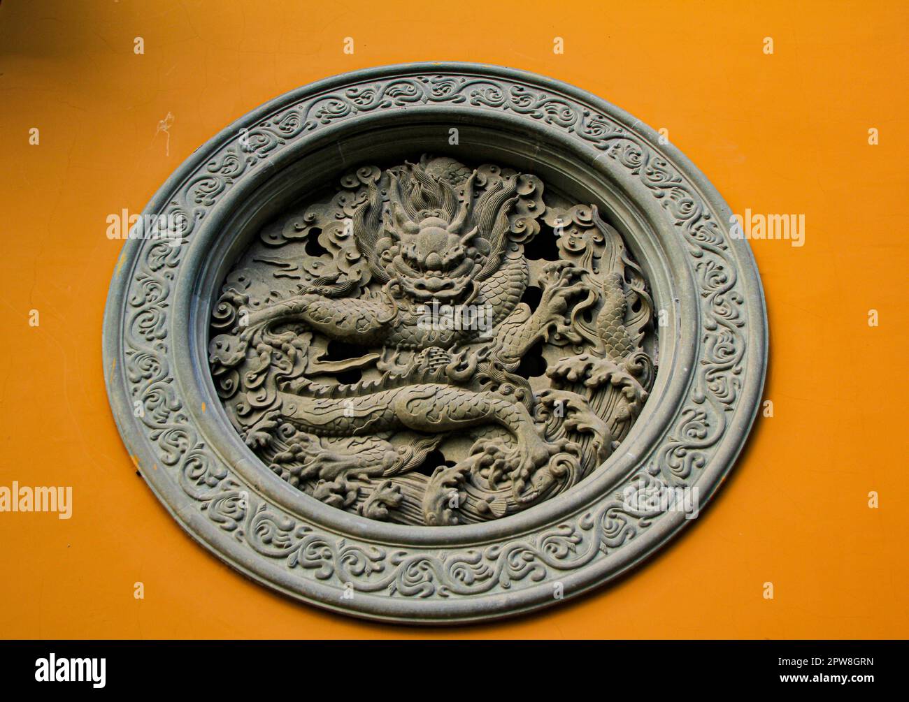 The close-up of Chinese stone carving in yellow background. Traditional ...