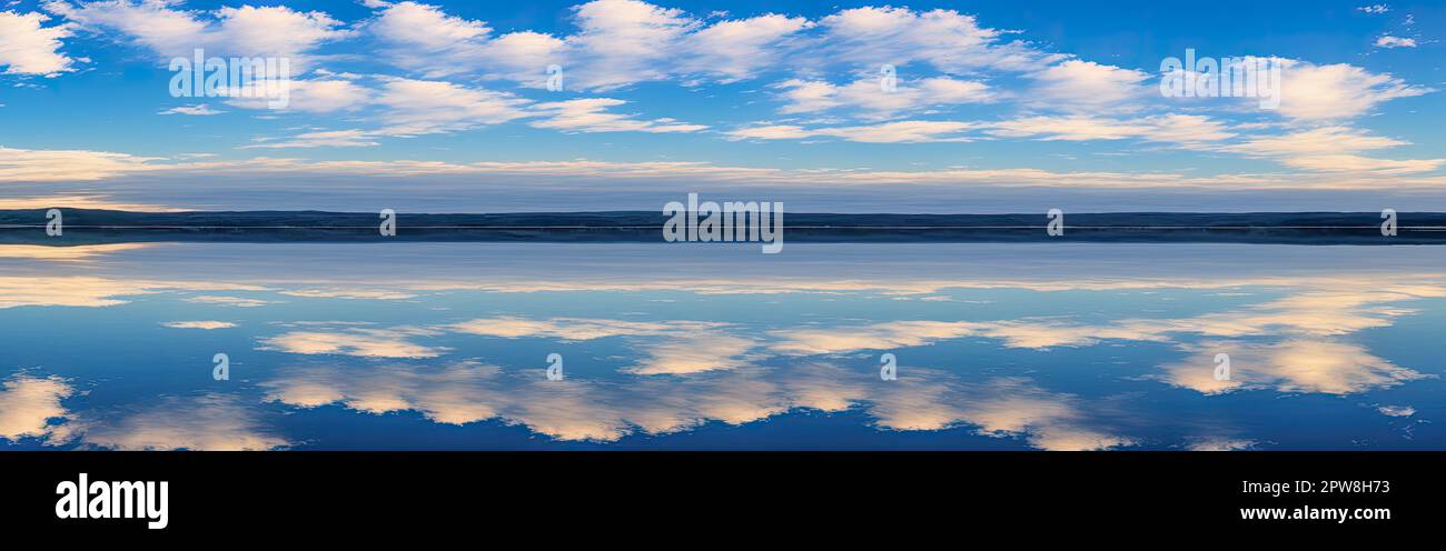Mirror reflection of clouds in lake water. White clouds in blue sky ...