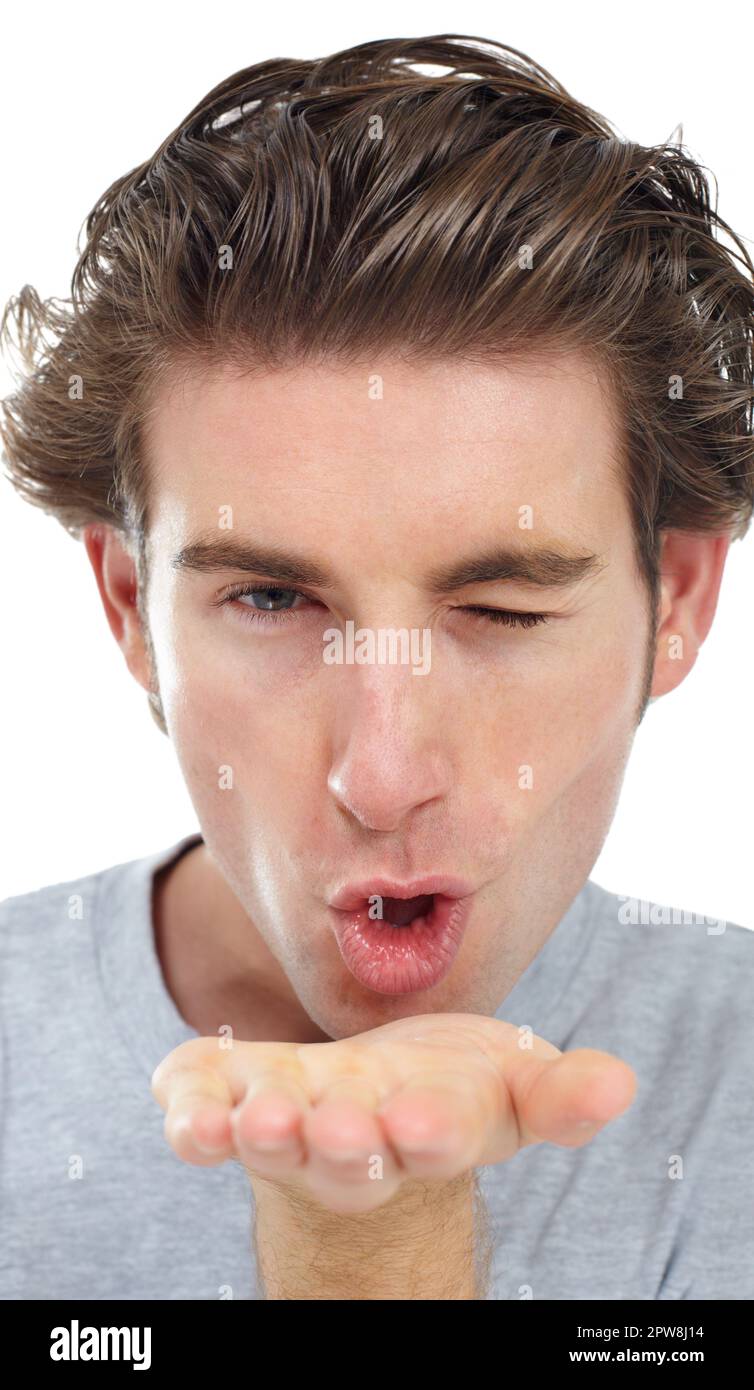 Wink, blowing a kiss and portrait of man in studio for flirting ...