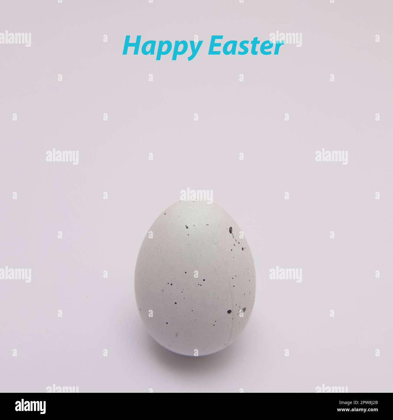 Easter white egg with black spots with copy space on a white background ...